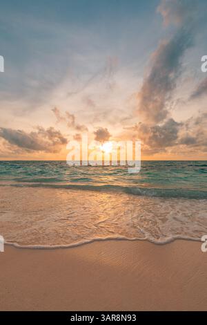 Closeup of sunset beach scenery golden sand, calm sea, and colorful sky ...