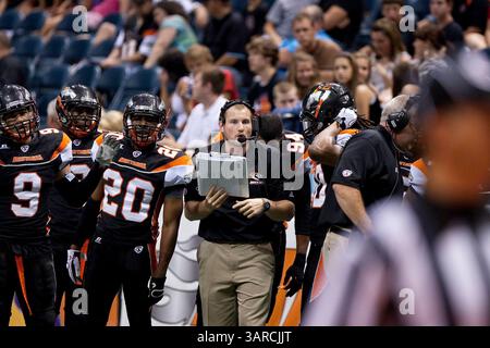 A coach hold up a play for special teams during a National team ...