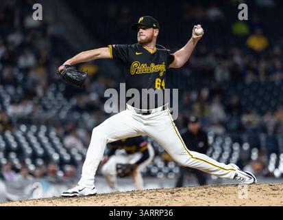 Pittsburgh Pirates pitcher Caleb Ferguson, right, hands the ball to ...