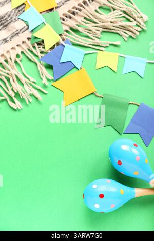 Frame made of Mexican maracas, flags and serape on green background ...