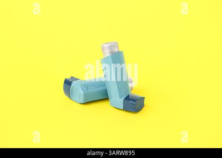 Asthma inhalers on yellow background Stock Photo - Alamy