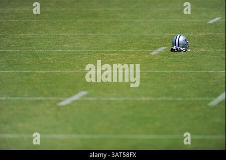 A Dallas Cowboys helmet rests on a Gatorade cooler during an NFL ...