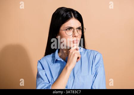 Charming businesswoman in glasses and striped shirt working with laptop ...