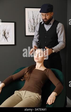 Psychologist working with patient during hypnosis session indoors Stock ...
