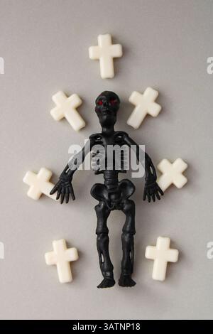 Faith beyond death, skull surrounded by crosses Stock Photo - Alamy