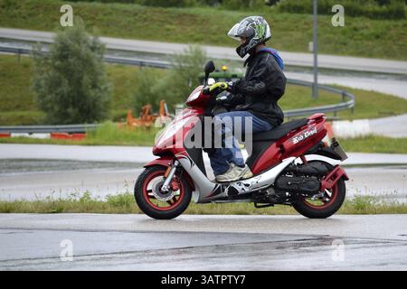 Moped riding technique training on the practice area Stock Photo - Alamy
