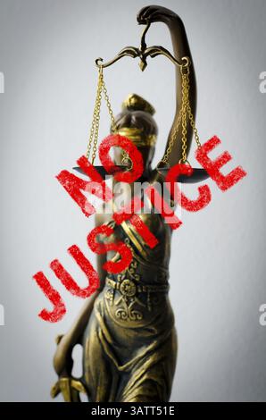 Statue of Justice with the sign no justice Stock Photo - Alamy
