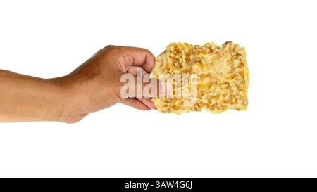 Hand holding tempe chips crispy (keripik tempe) with white background ...
