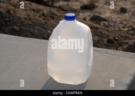 milk jug filled a quarter full with water Stock Photo - Alamy