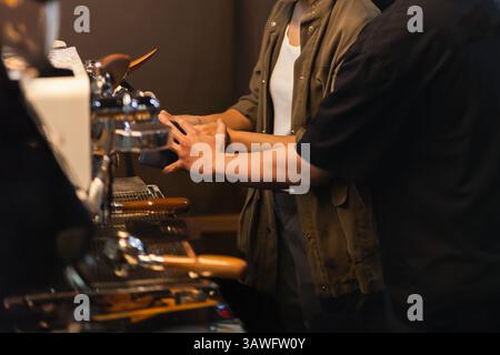 Barista coaching teaching woman to brew coffee in cafe Stock Photo - Alamy