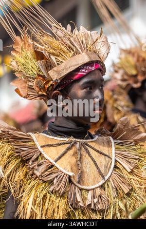 Participant in black face paint to honor the Ati tribe and wearing ...