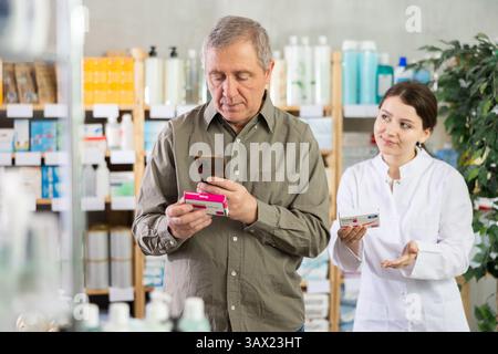 Man buyer scans paracetamol qr code with woman pharmacist Stock Photo ...