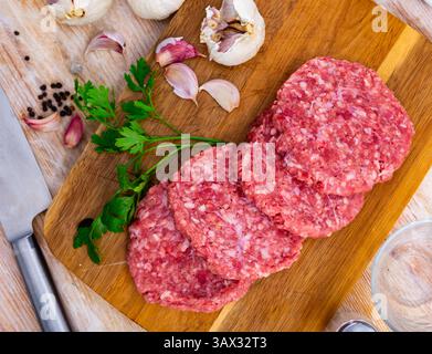 Farmer's uncooked beef and pork burgers for BBQ, grilling or frying on ...