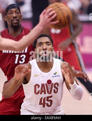 Cleveland Cavaliers guard Ty Jerome, left, passes over Miami Heat ...