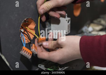 Installing electrical circuits on a wall - close-up Stock Photo - Alamy