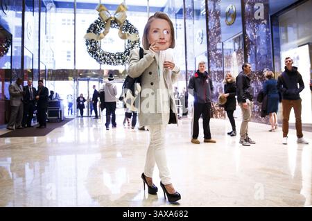 A man with a Hillary Clinton mask walks through the lobby of Trump ...