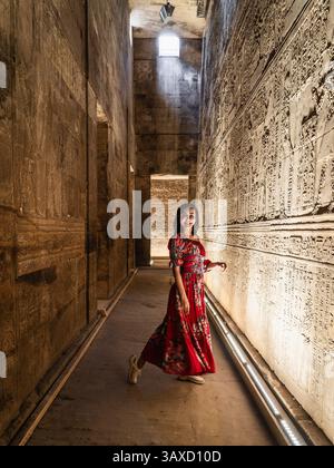 woman exploring the temple of Horus close to the river Nile / Egypt ...