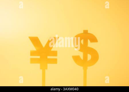 Two yellow currency symbols, the Chinese Yuan (¥) and Dollar ($), set ...