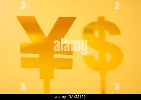 Two yellow currency symbols, the Chinese Yuan (¥) and Dollar ($), set ...