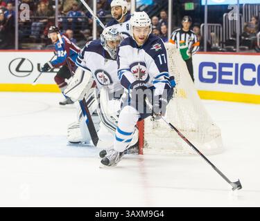 Winnipeg Jets center Adam Lowry (17), left, pressures St. Louis Blues ...
