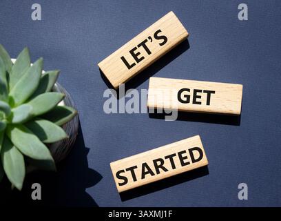 Lets get started symbol. Concept words Lets get started on wooden ...