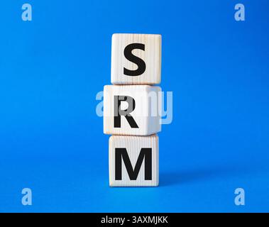 SRM - Sustainability Risk Management symbol. Wooden cubes with word SRM ...