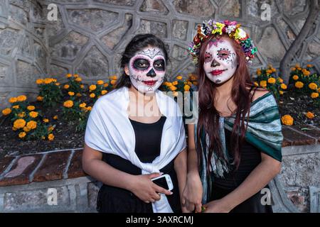 Young women, dressed as La Catrina, take part in the Day of the Dead ...