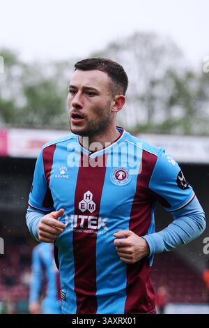 Scunthorpe , United Kingdom . 21 April, 2025. Callum Roberts tries to ...