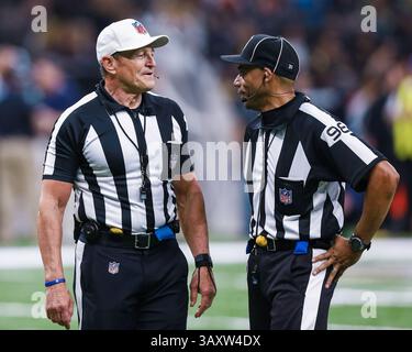 Head linesman Greg Bradley (98) and line judge Mark Perlman (9) during ...