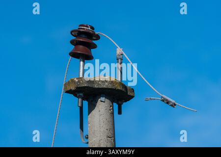 Silent Current: Old Concrete Electric Post Against Clear Sky Stock ...