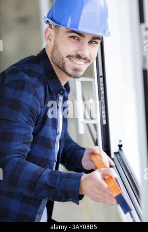 A building level on a window sill during house construction. The ...