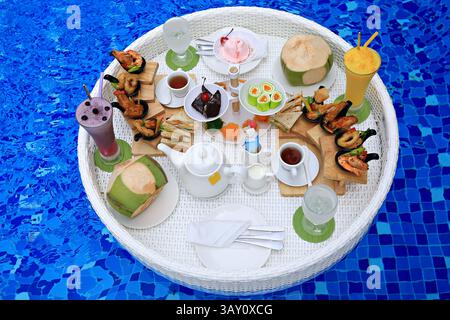 Set of floating breakfast tray in swimming pool with Sandwich, Fried ...