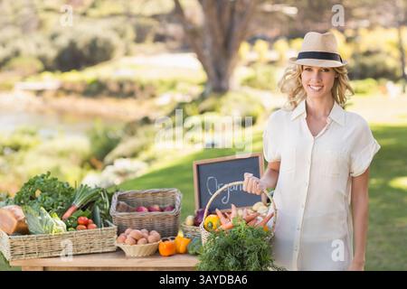 wicker basket with fresh apples and lettuce in the garden, close-up ...