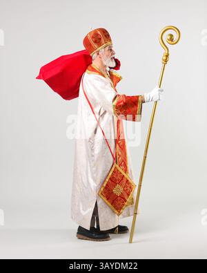 Saint Nicholas with sack on light grey background Stock Photo - Alamy