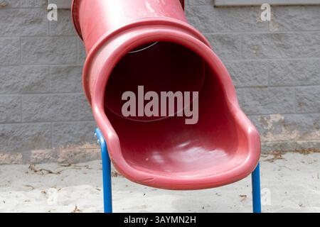 Red Plastic Slide For Kids Fun Playground Stock Photo - Alamy