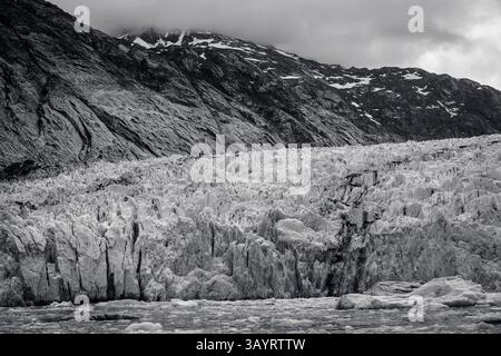 Cold sloping land and low clouds over Dawes Glacier in Alaska Stock ...