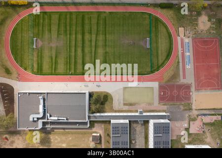 School Complex with Sports Fields and Urban Landscape - Aerial View ...