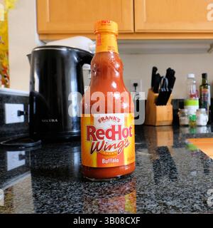 A glass bottle of Frank's RedHot Buffalo Wings Sauce on a kitchen ...