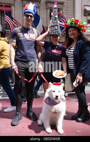 A woman in an American flag-themed shirt and a cowboy hat attends the ...