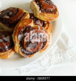 Fragrant roll of walnut brioche pastry, decorated with a veil of icing ...