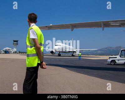 Unmarked cargo jet airplane landing side view Stock Photo - Alamy