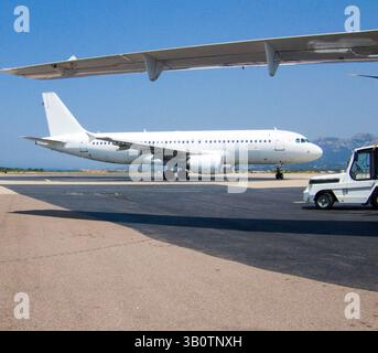 Unmarked cargo jet airplane landing side view Stock Photo - Alamy