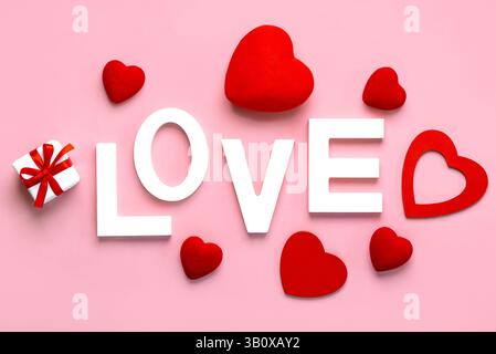 Gift boxes, word LOVE and hearts on lilac background. Valentine's Day ...