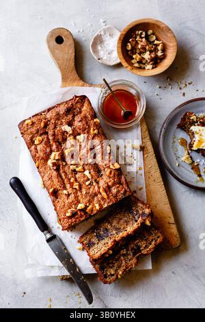 Baking paper with bread and knife on white wooden background Stock ...