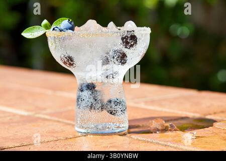 Blueberry Seltzer with fresh blueberries at an outside pool party Stock ...