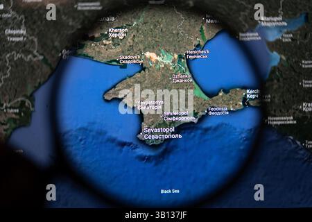 Map of Crimea seen through magnifying glass on Google maps. Crimea is a ...