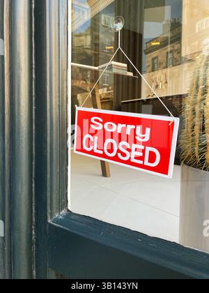 "Sorry, we are closed" sign on shop door at night Stock Photo - Alamy