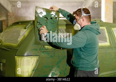 A man wearing protective gear sprays disinfectant around a Christmas ...