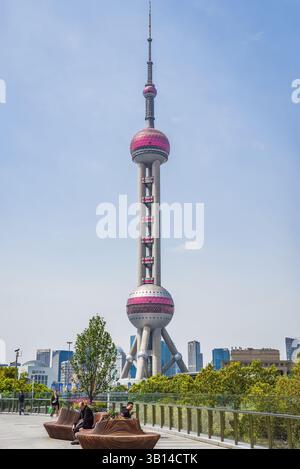 Shanghai, China - 1 April 2025: Vibrant pink flowers frame the Shanghai ...