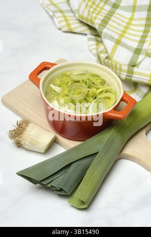 Cut the leek into rings, board, bowl and knife Stock Photo - Alamy